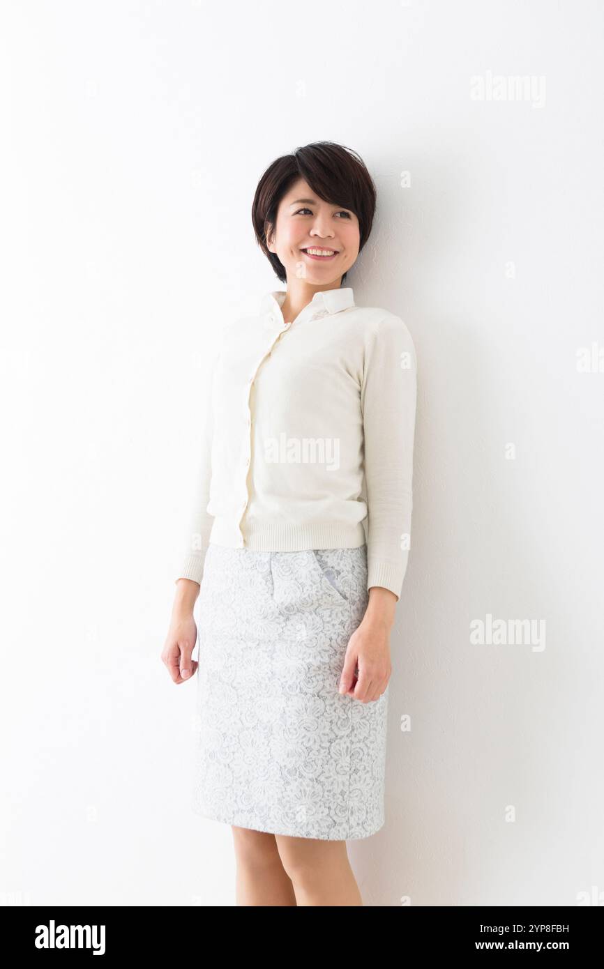 Woman standing with a smile Stock Photo - Alamy