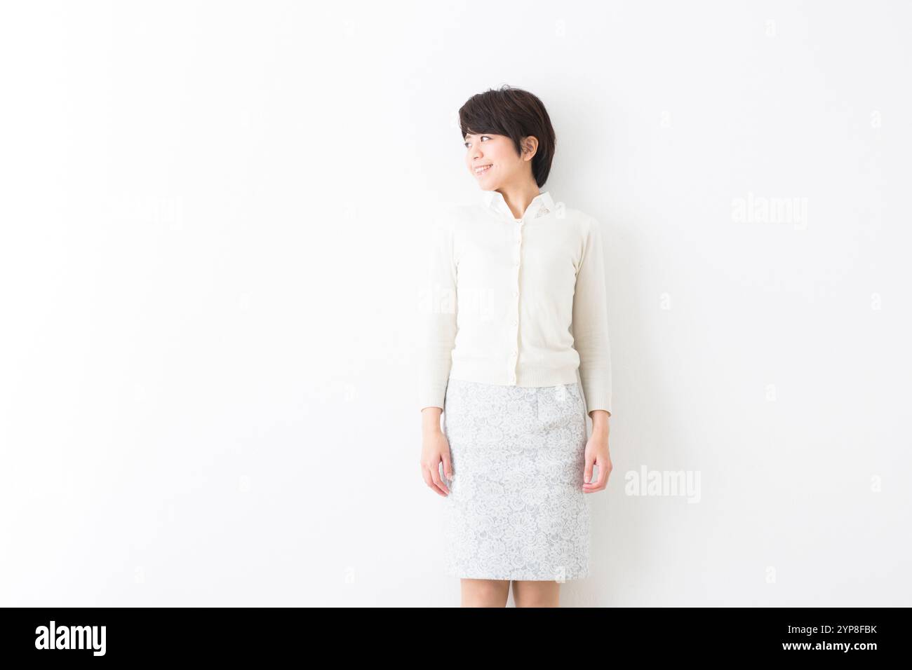 Woman standing with a smile Stock Photo - Alamy
