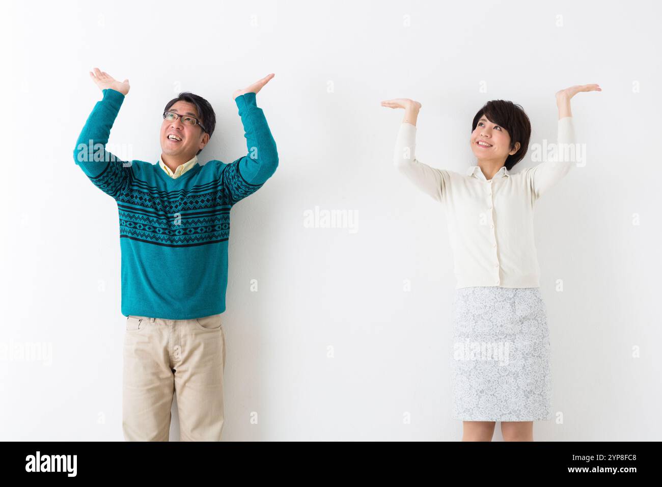 Couple striking a guiding pose Stock Photo - Alamy