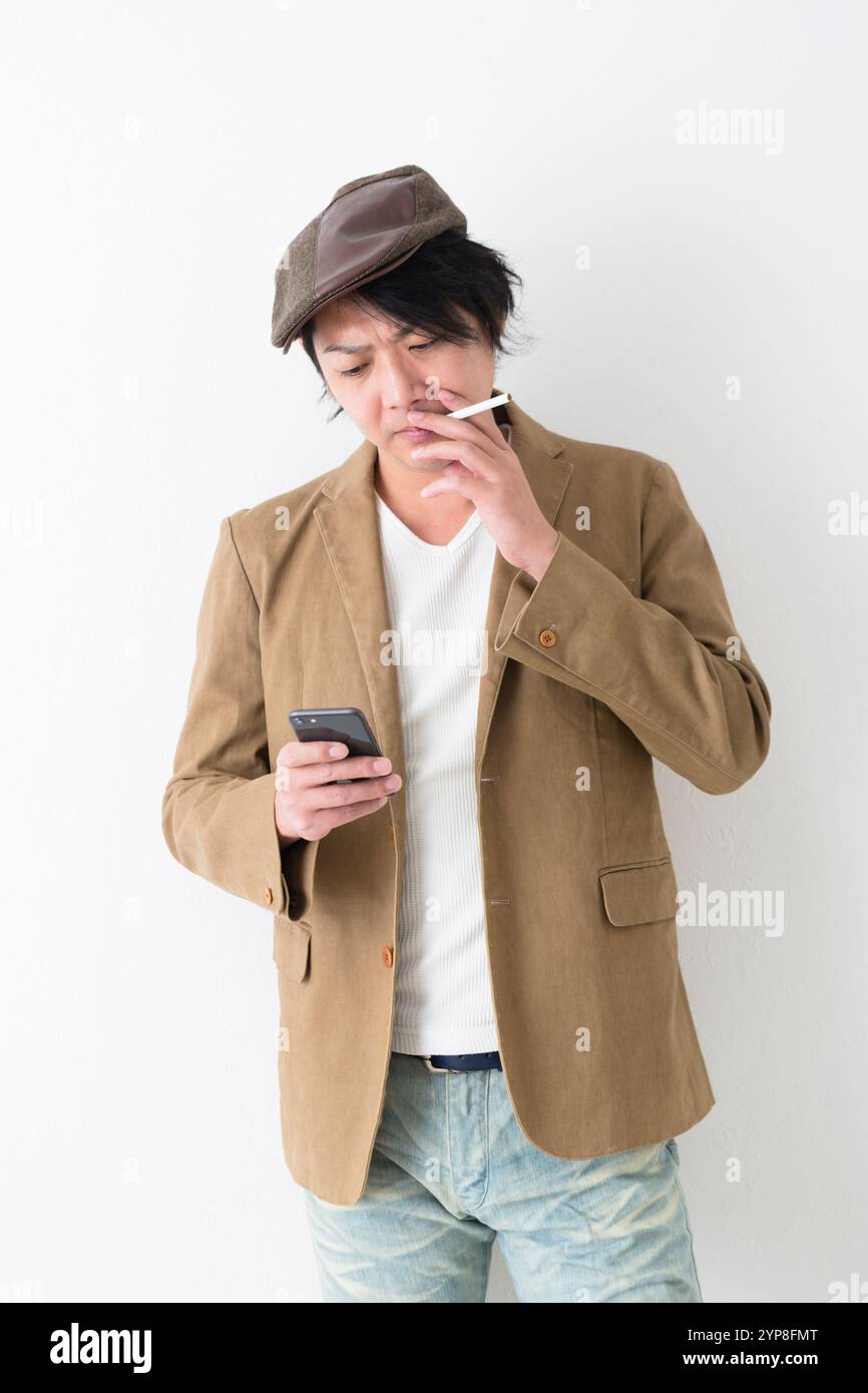 Middle man smoking a cigarette Stock Photo - Alamy