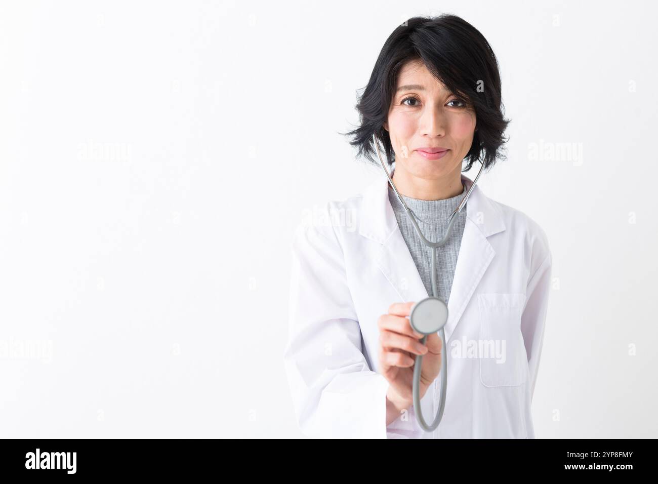 Female doctor using stethoscope Stock Photo - Alamy