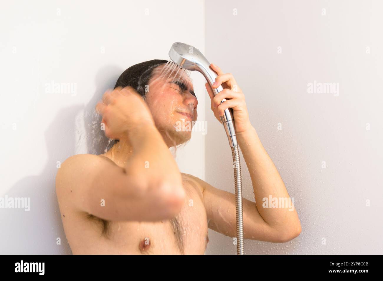 Man taking a shower Stock Photo - Alamy