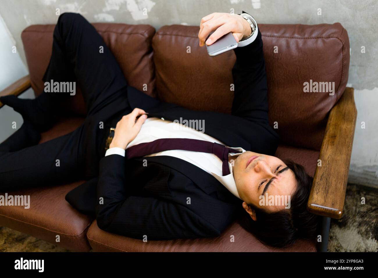 Man sleeping on sofa Stock Photo - Alamy
