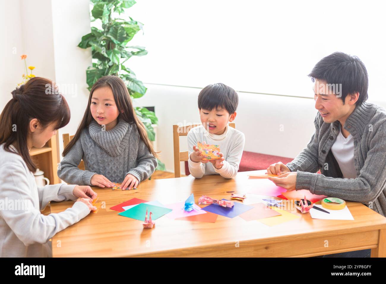 Boy doing origami hi-res stock photography and images - Alamy