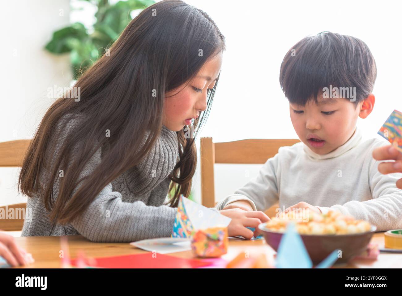 Boy doing origami hi-res stock photography and images - Alamy