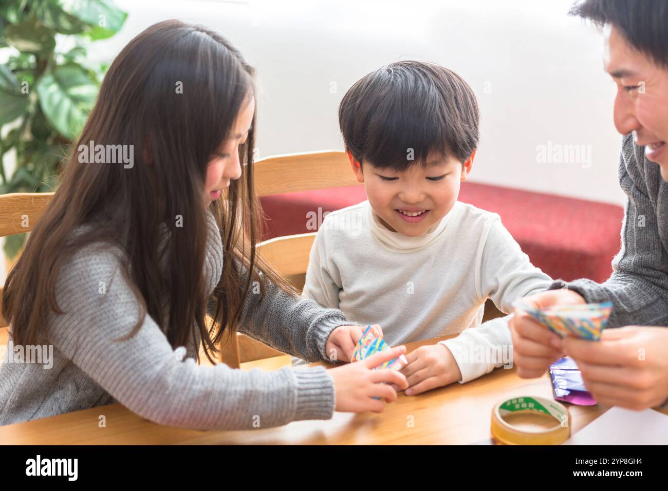 Boy doing origami hi-res stock photography and images - Alamy