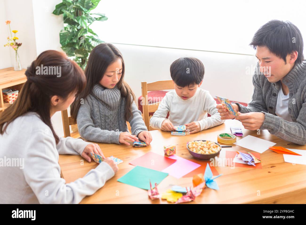 Boy doing origami hi-res stock photography and images - Alamy