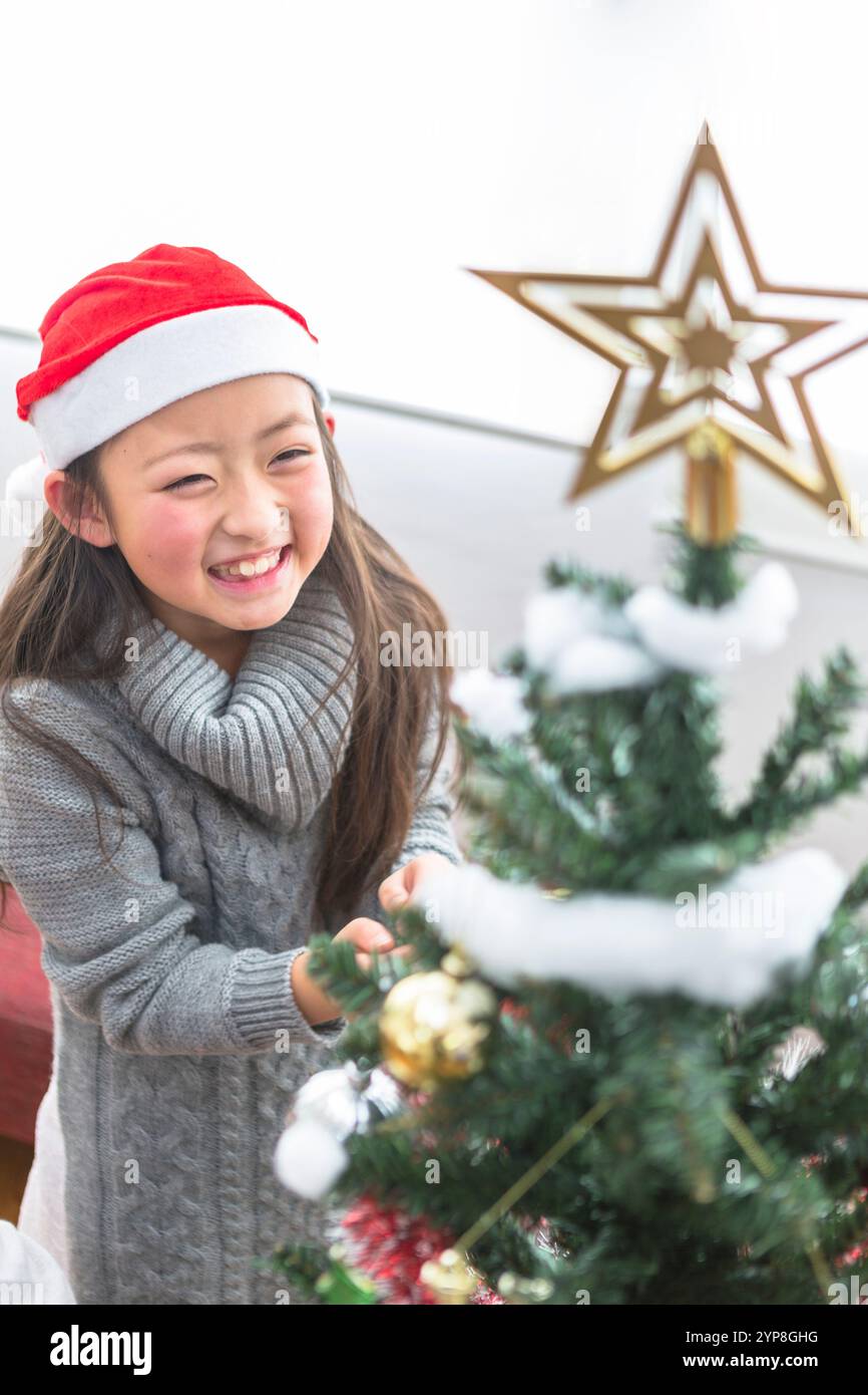 Family decorating the tree Stock Photo - Alamy