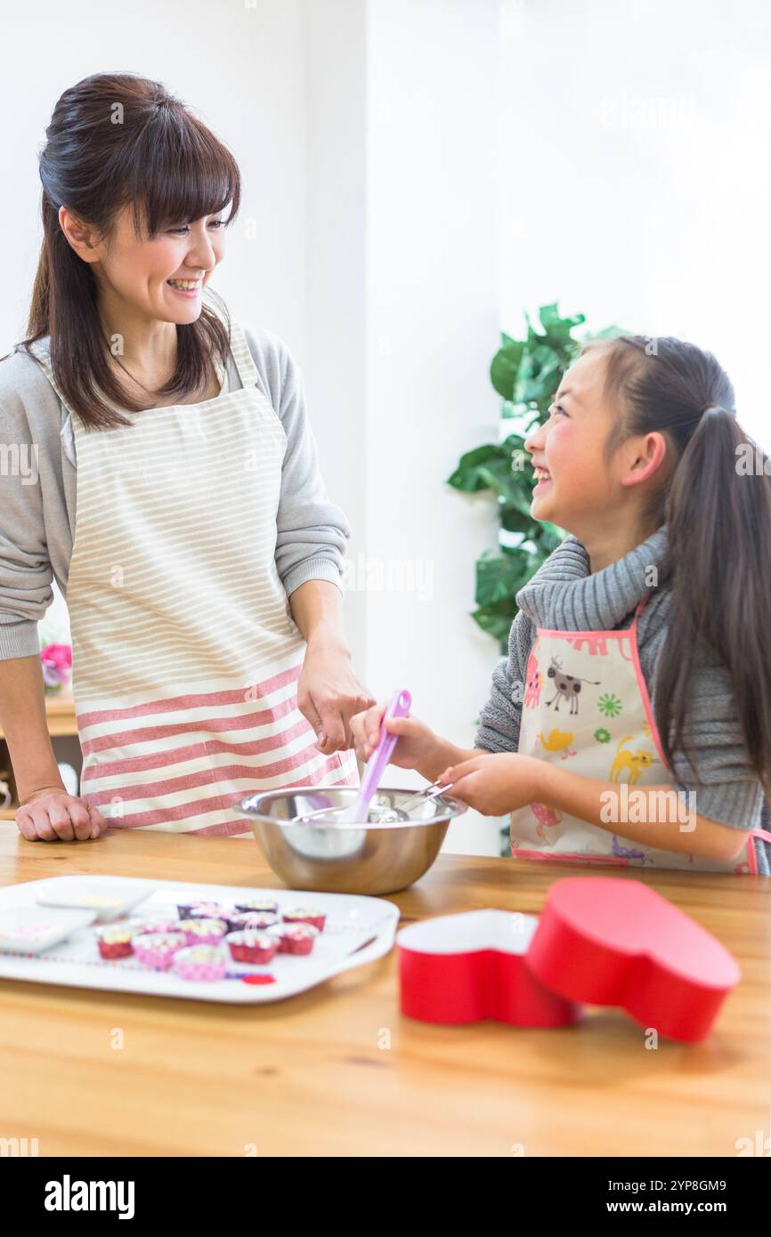 Mother and daughter making chocolate Stock Photo - Alamy