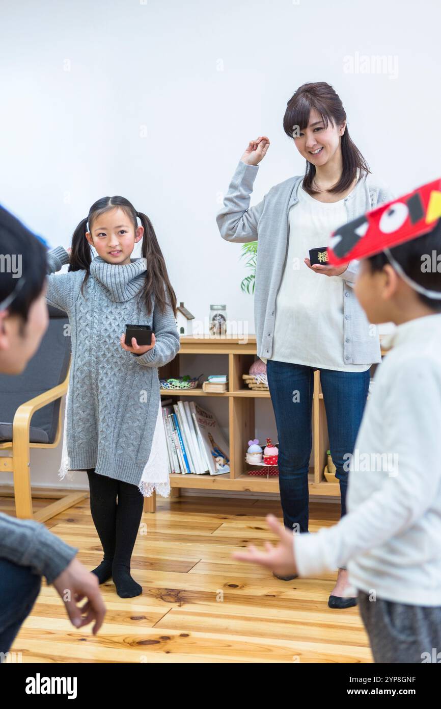 Family members throwing beans on Setsubun Stock Photo - Alamy