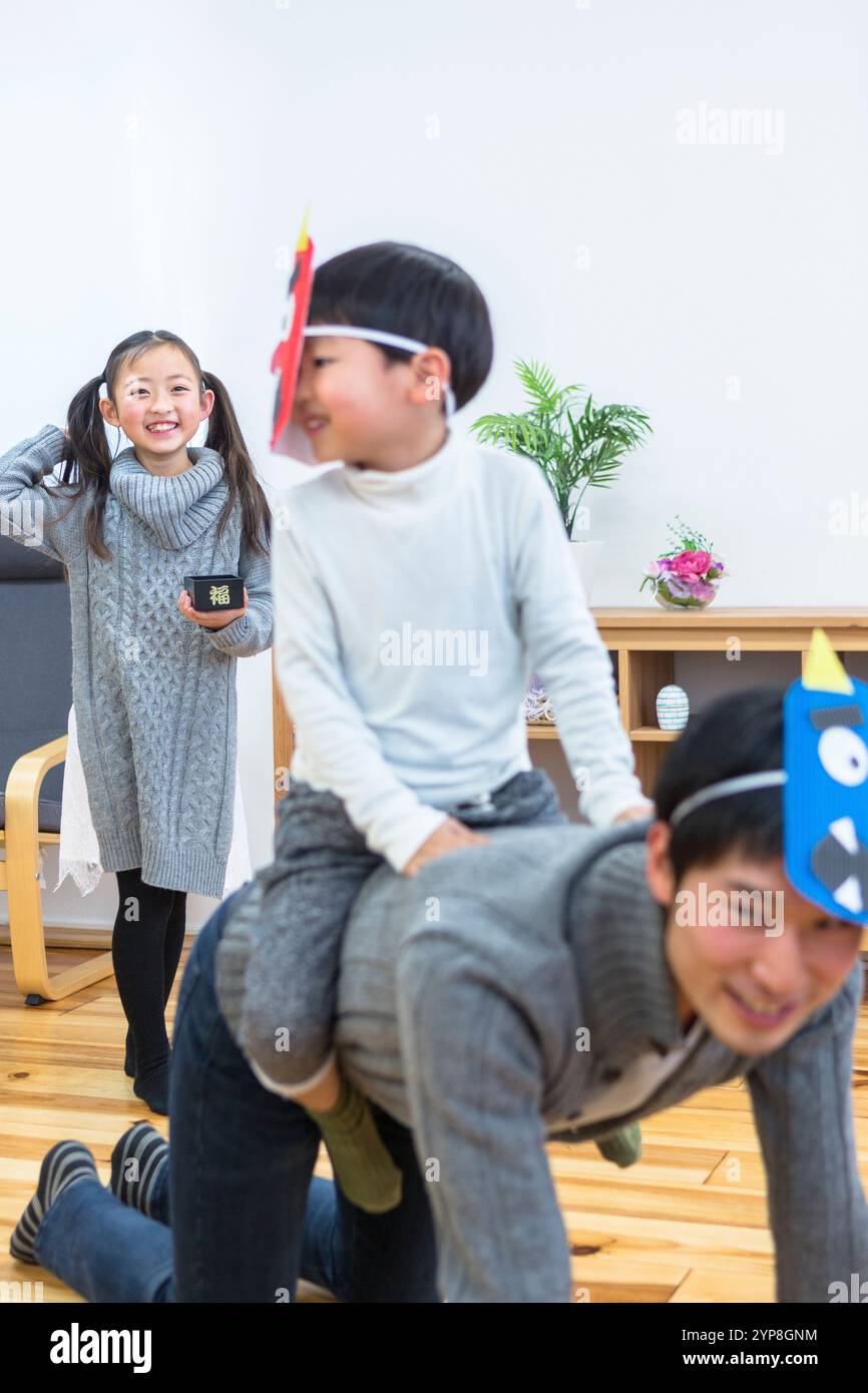 Family members throwing beans on Setsubun Stock Photo - Alamy