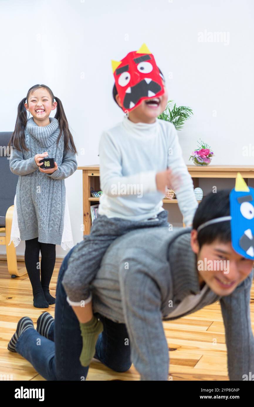 Family members throwing beans on Setsubun Stock Photo - Alamy