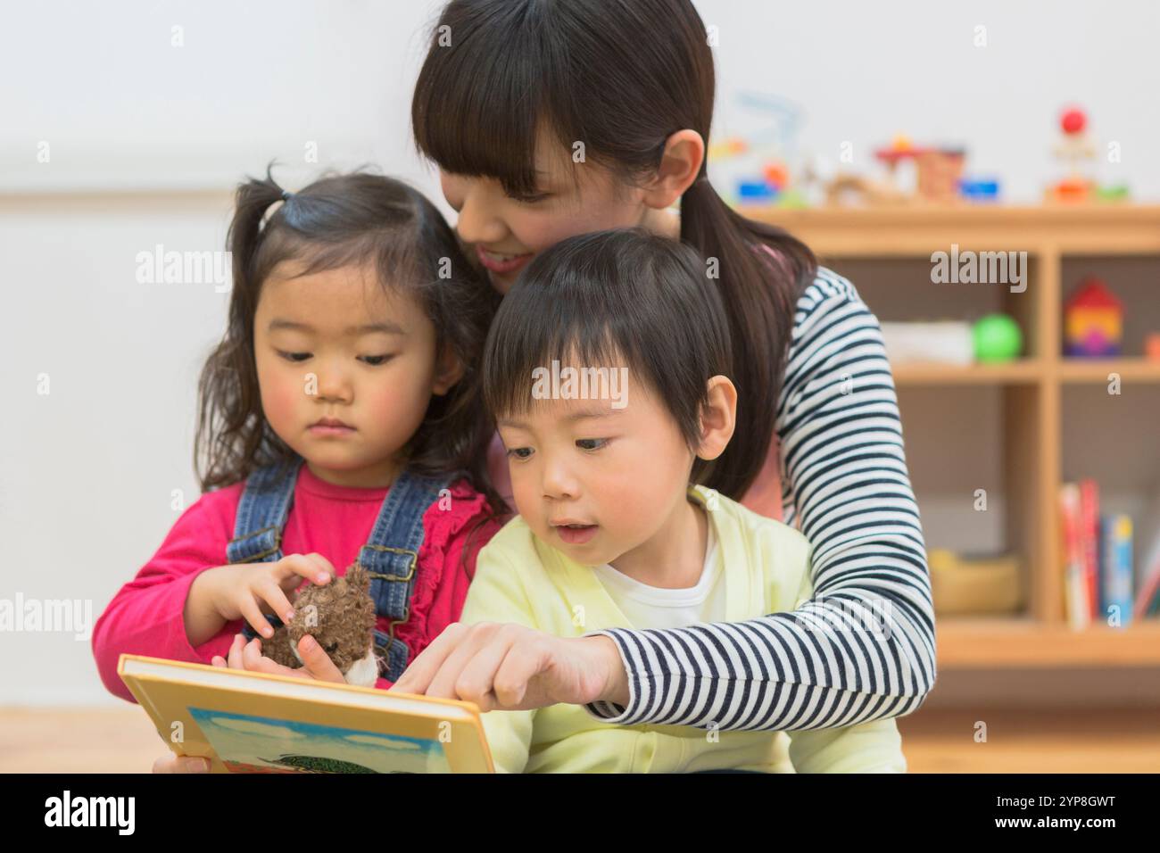 Children reading a picture book Stock Photo - Alamy