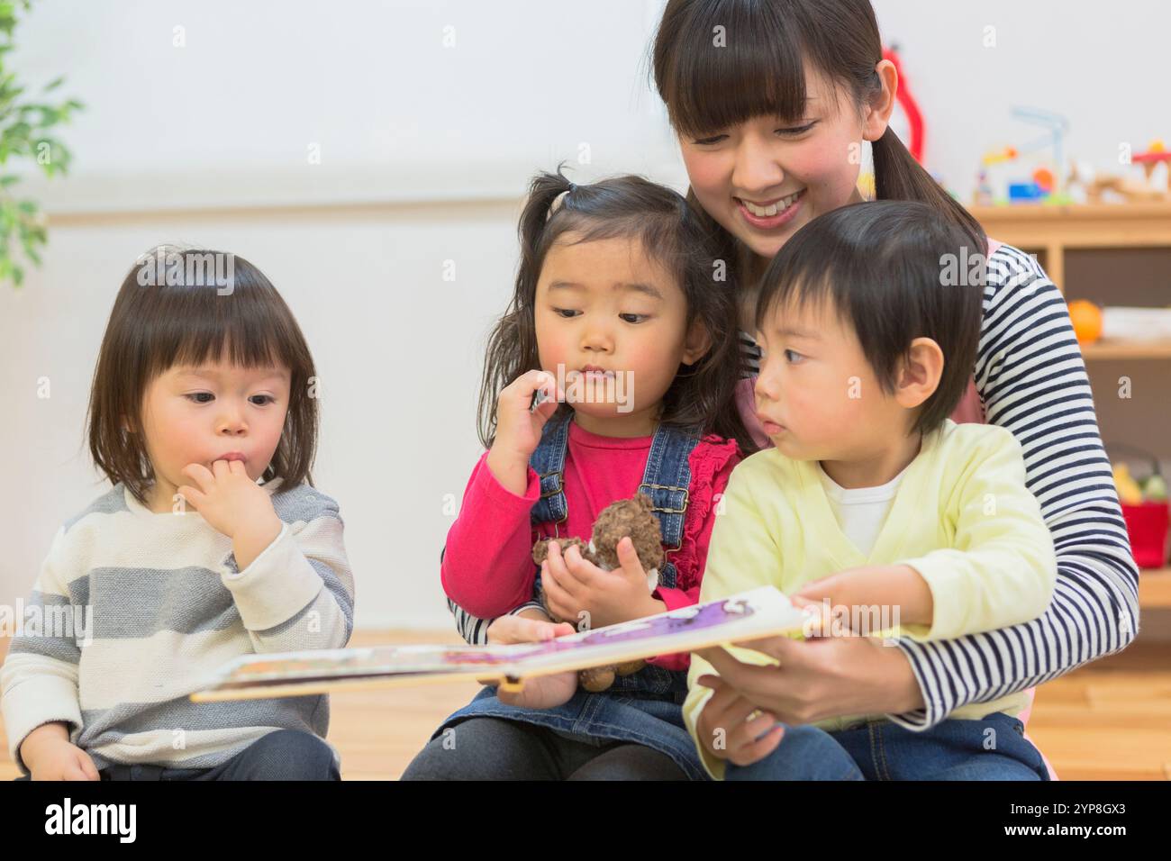 Children reading a picture book Stock Photo - Alamy