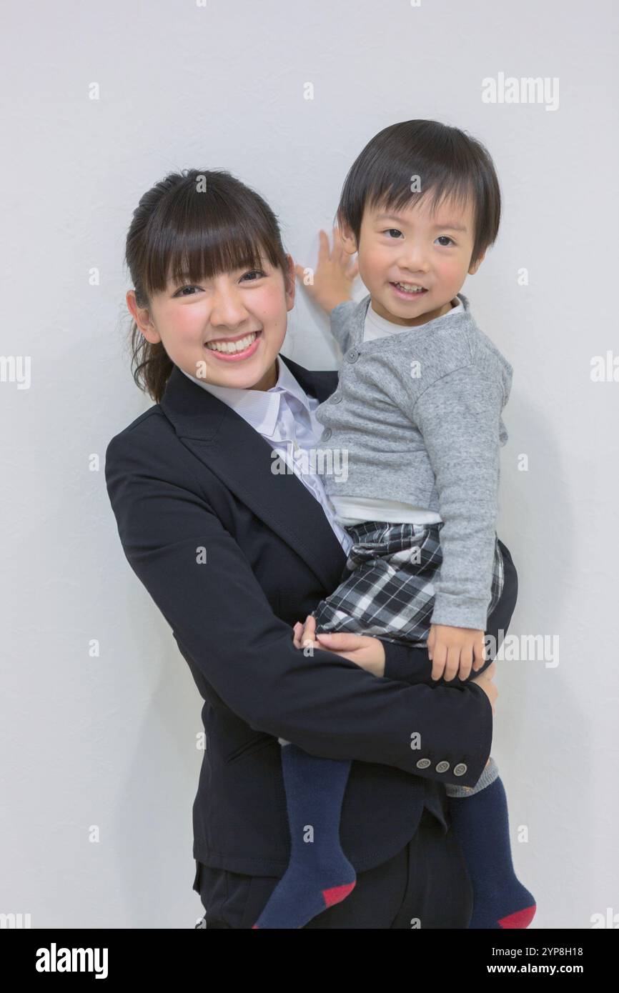Mother carrying a child Stock Photo - Alamy