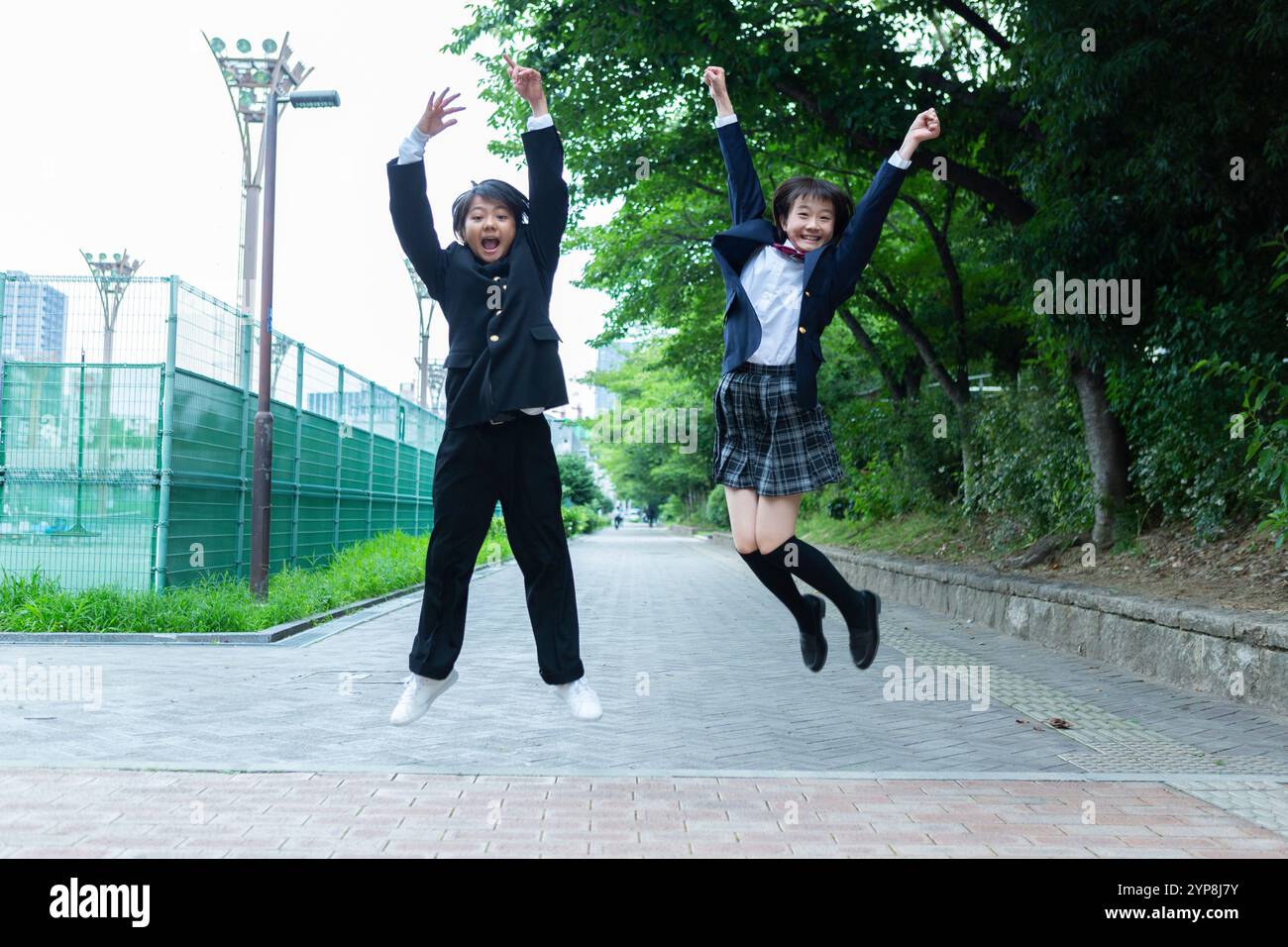 Junior high school students jumping Stock Photo - Alamy