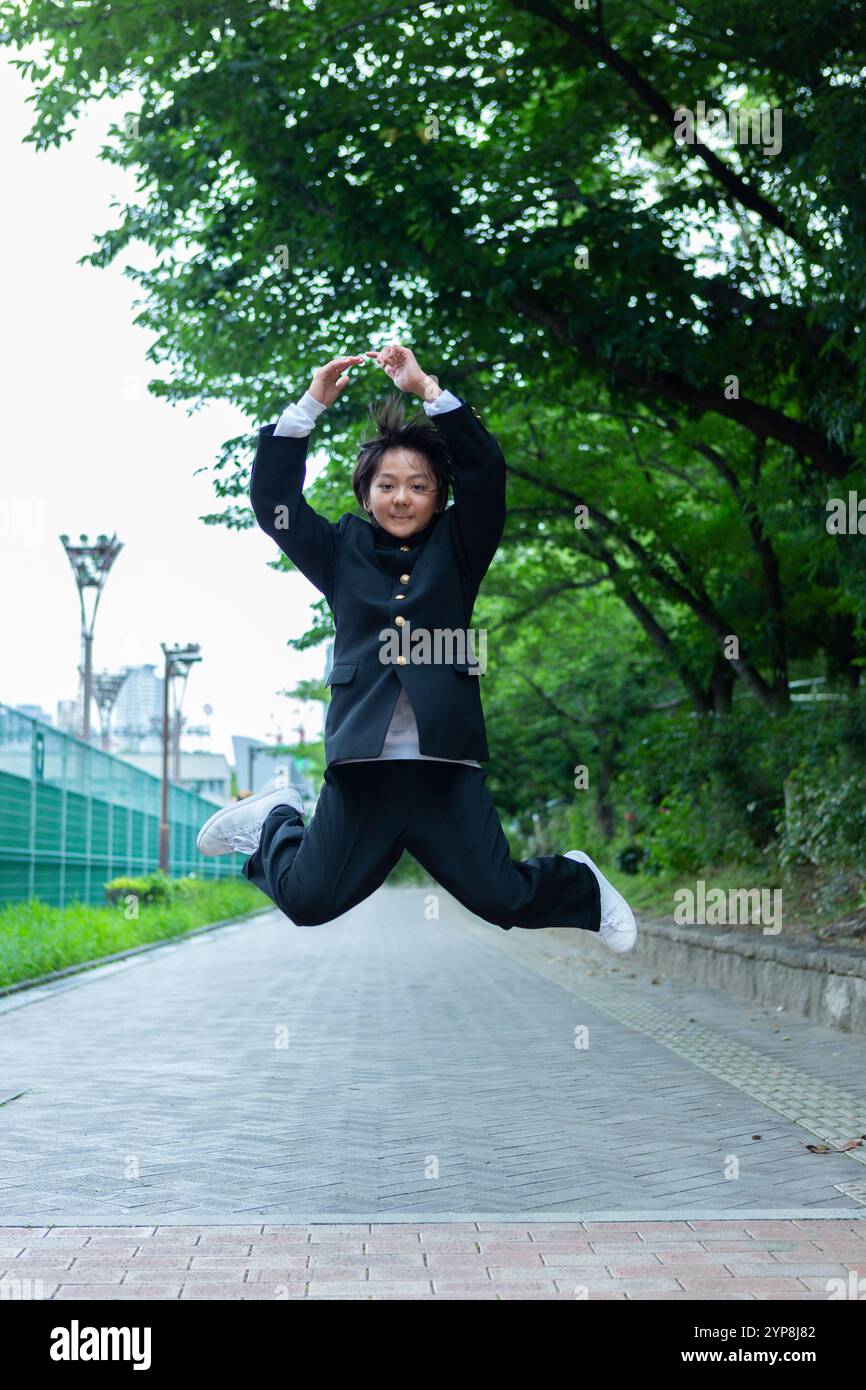 Junior high school students jumping Stock Photo - Alamy