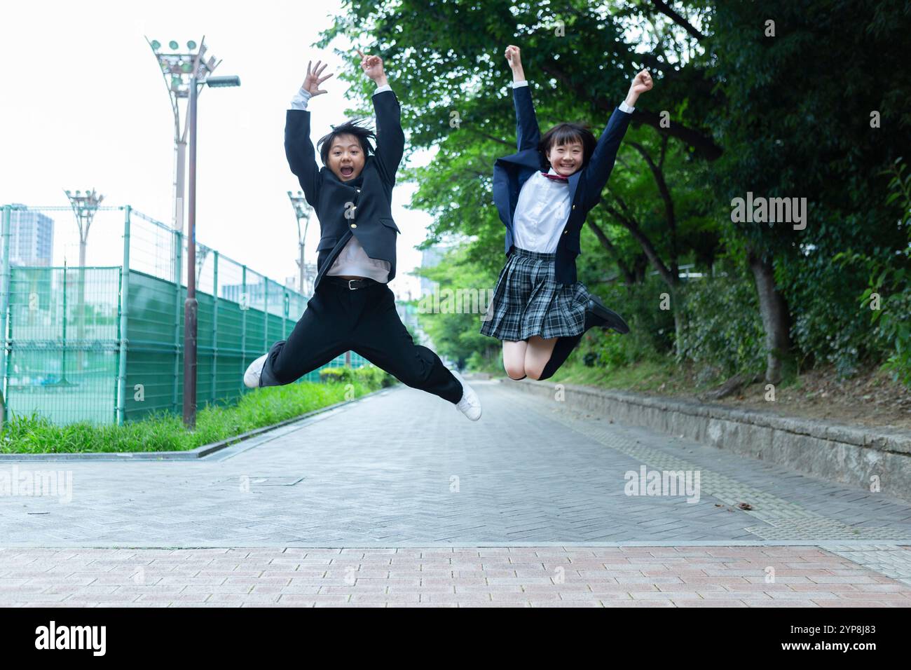 Junior high school students jumping Stock Photo - Alamy
