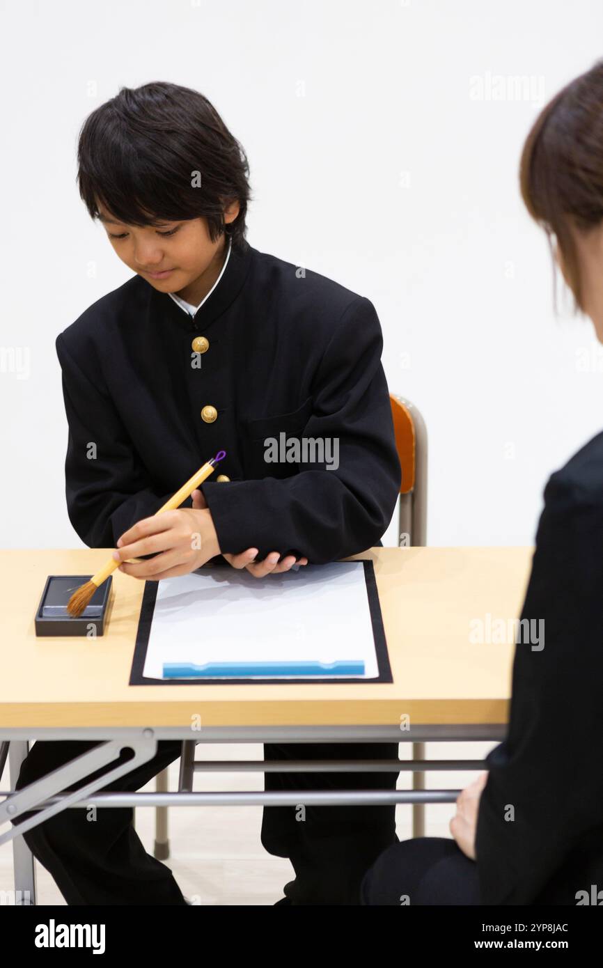 Junior high school student doing calligraphy Stock Photo - Alamy
