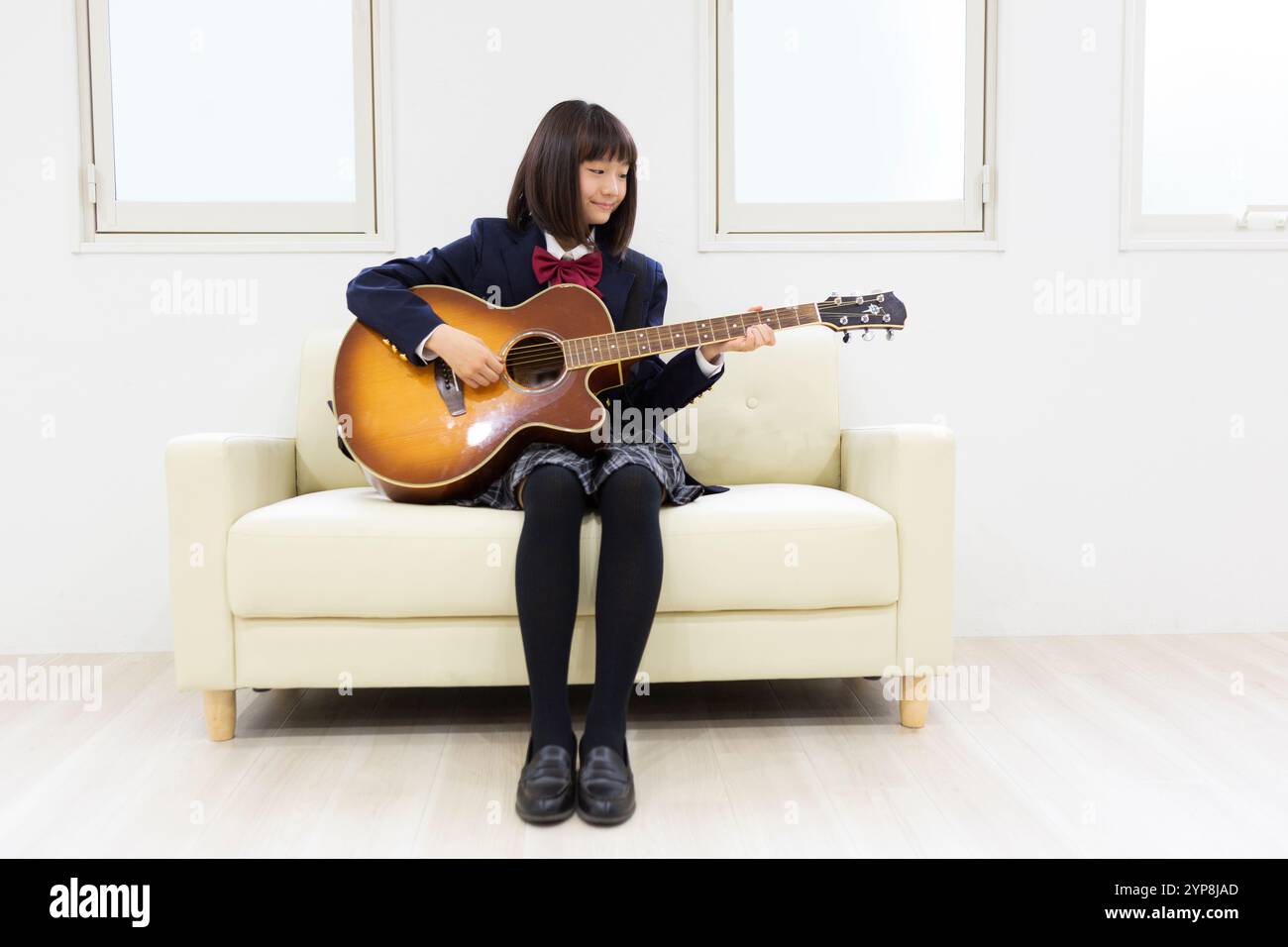 Junior high school student playing guitar Stock Photo - Alamy