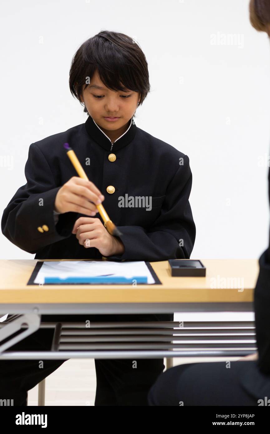 Junior high school student doing calligraphy Stock Photo - Alamy