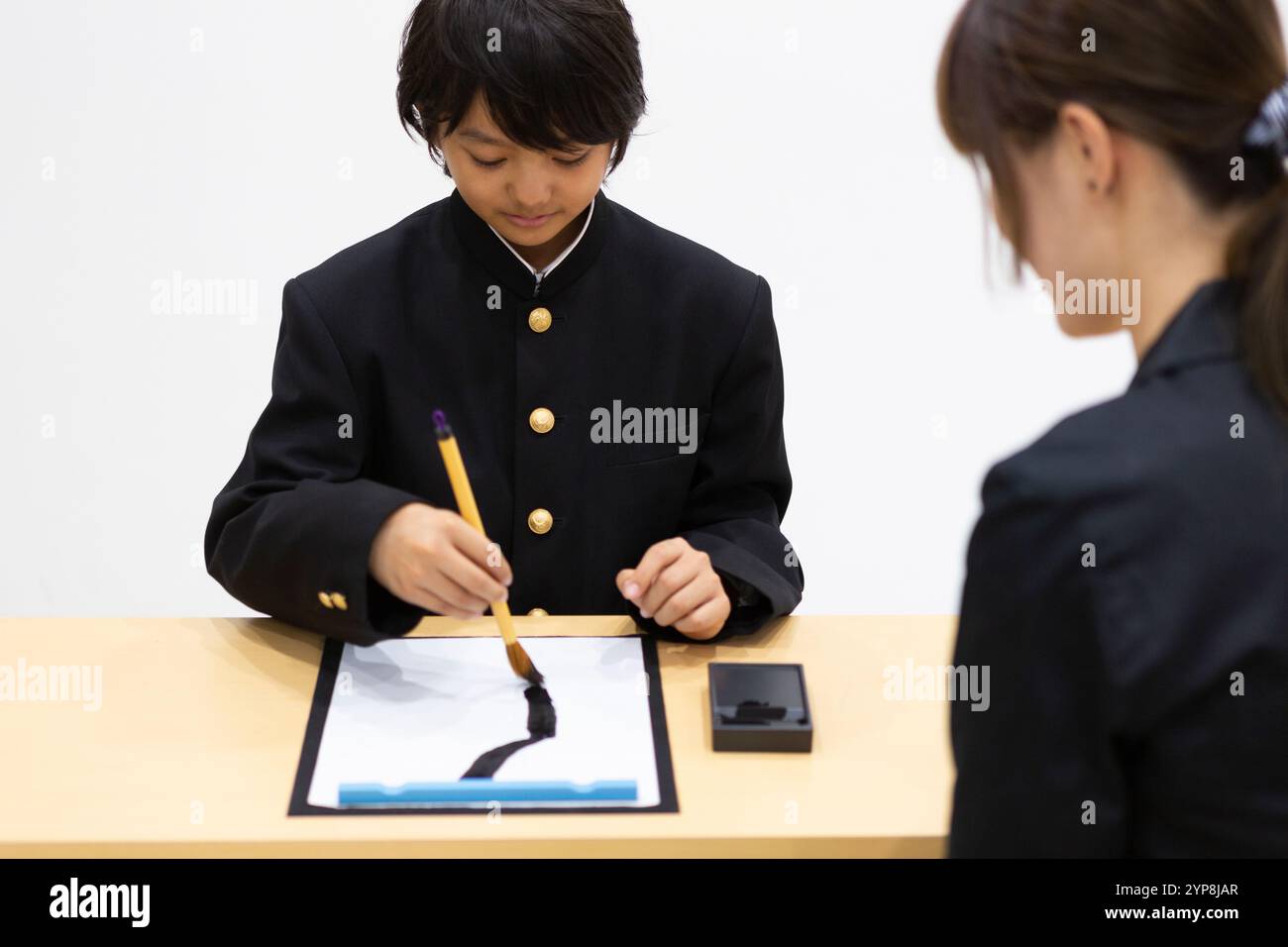 Junior high school student doing calligraphy Stock Photo - Alamy