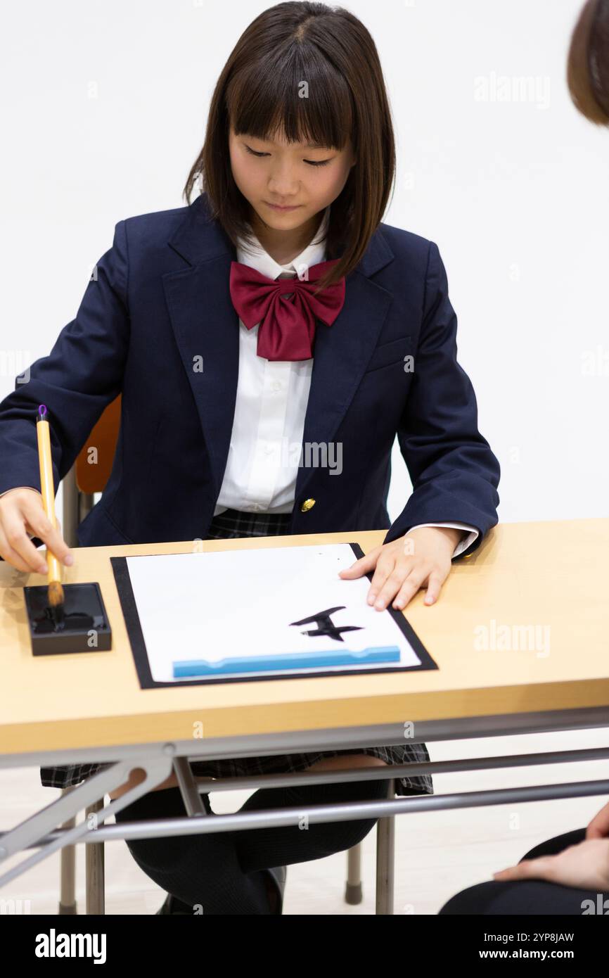 Junior high school student doing calligraphy Stock Photo - Alamy