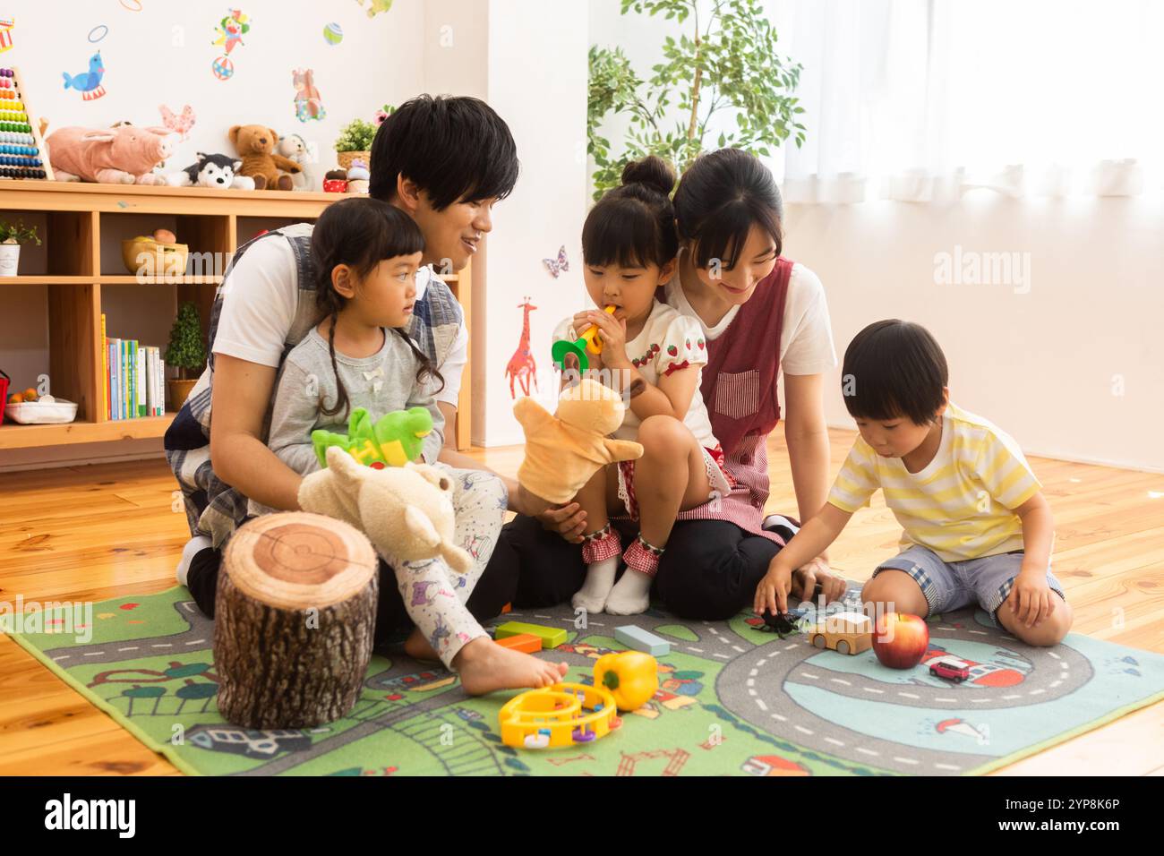 Children playing in nursery school and nursery staff Stock Photo - Alamy