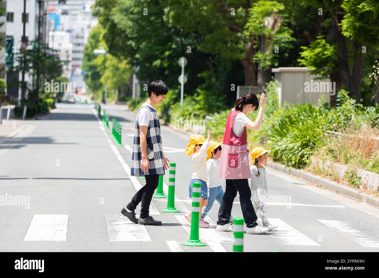 Nursery school teacher and children taking a walk Stock Photo - Alamy