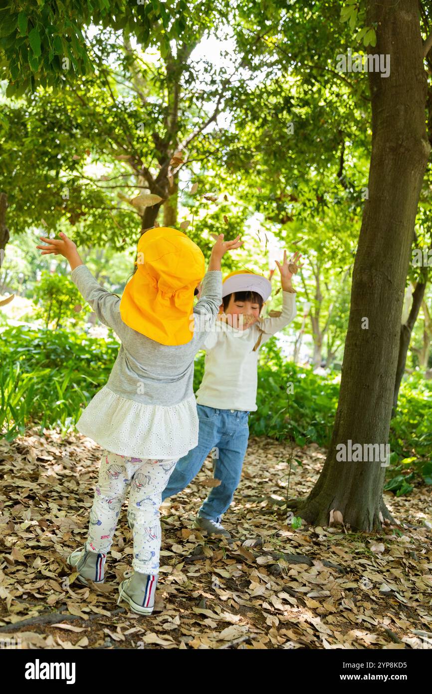 Girl playing fallen dry leaves hi-res stock photography and images - Alamy