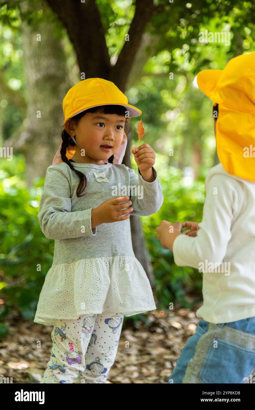 Girl playing fallen dry leaves hi-res stock photography and images - Alamy