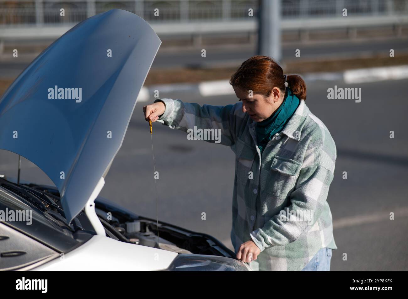 Woman checking oil level hi-res stock photography and images - Alamy