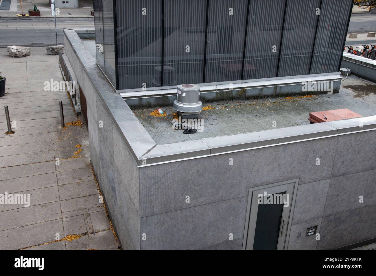 Pair of black shoes and an empty tetra pack beverage container left on ...