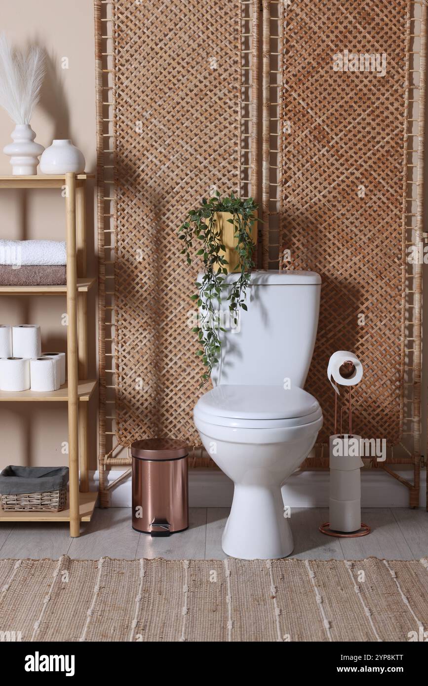 Ceramic toilet bowl, folding screen and necessities in restroom Stock ...