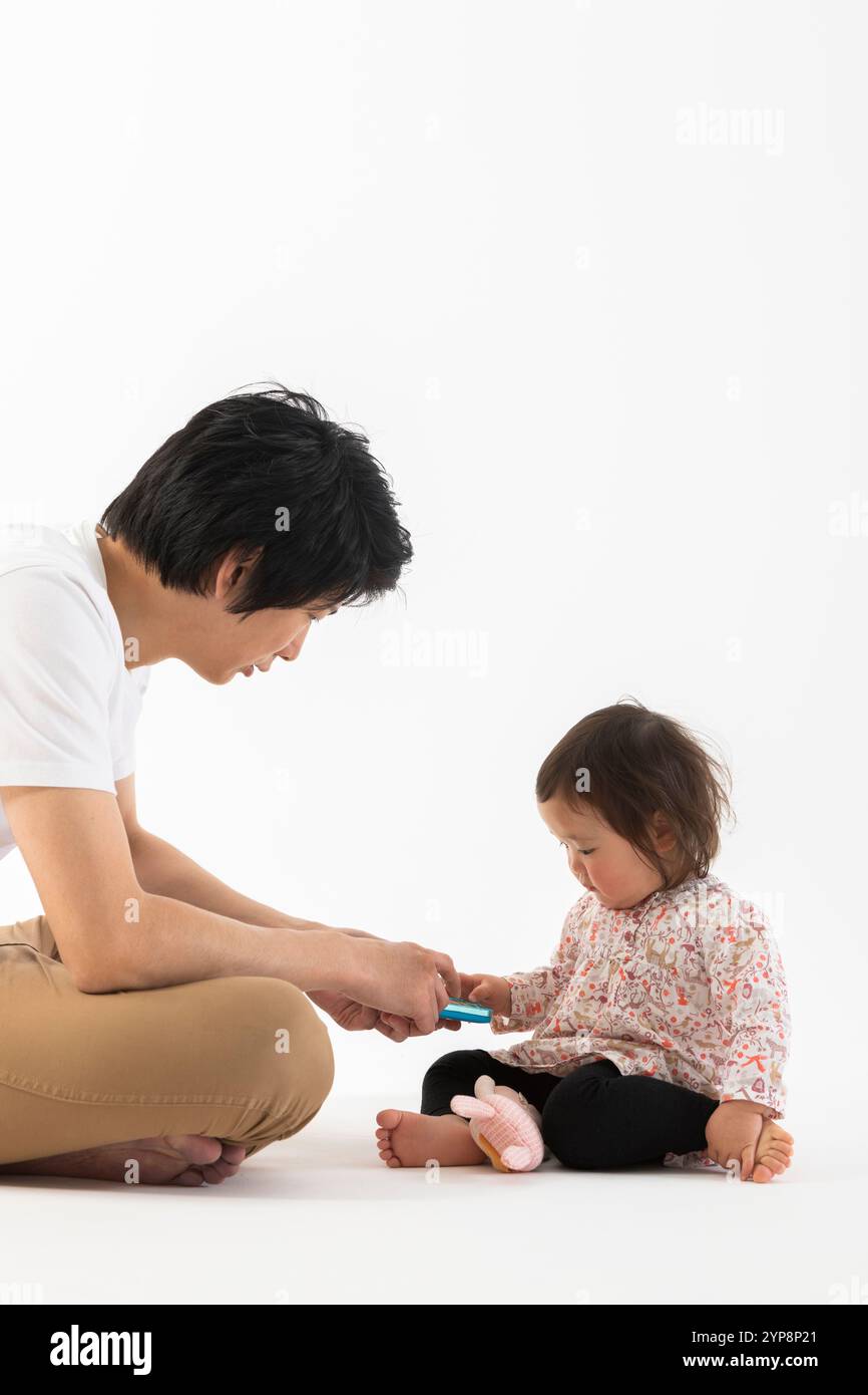 Child and father playing with toys Stock Photo - Alamy