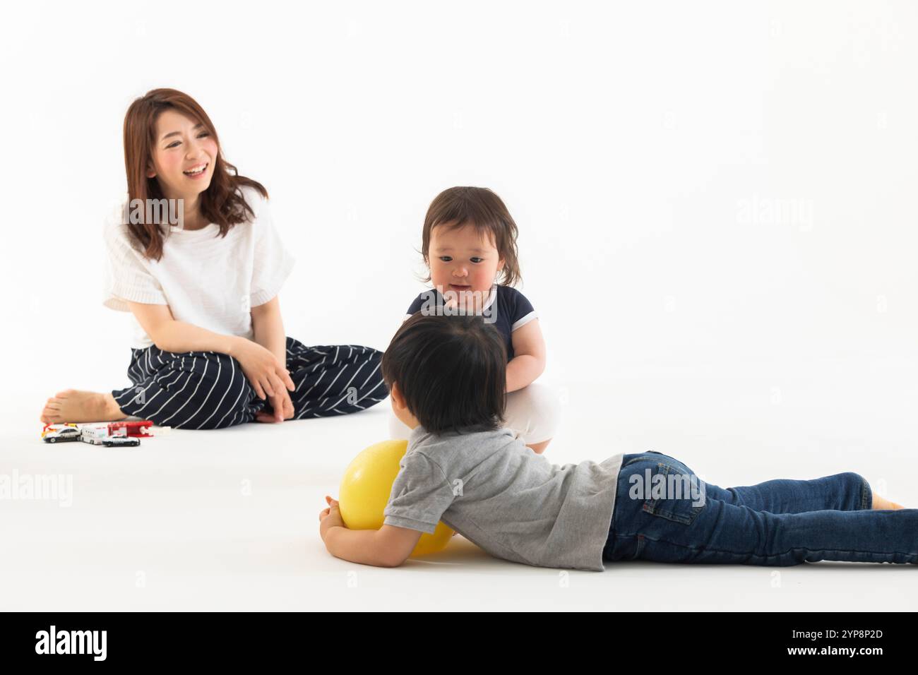 Parents playing with child Stock Photo - Alamy