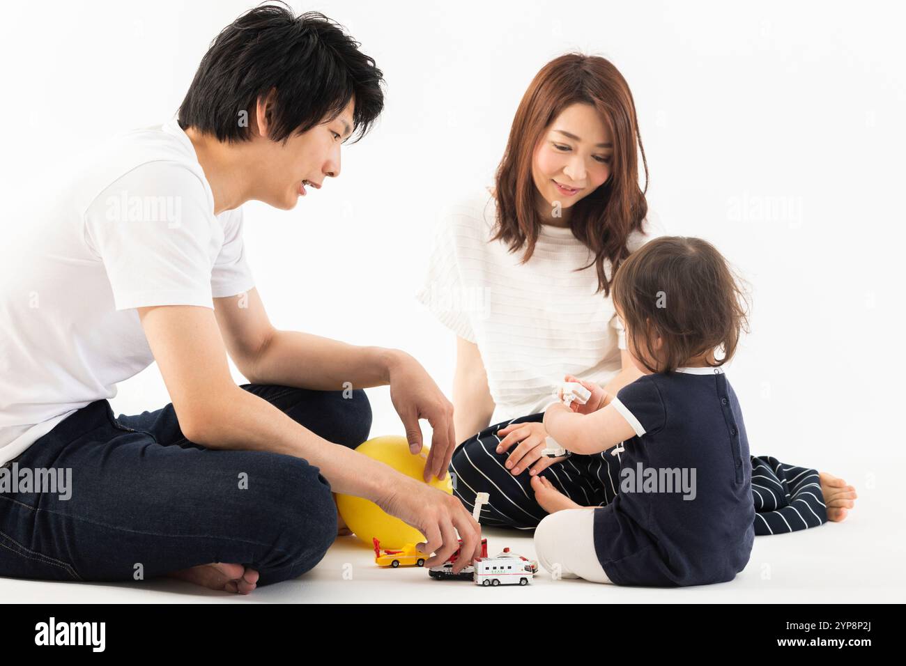 Parents playing with child Stock Photo - Alamy