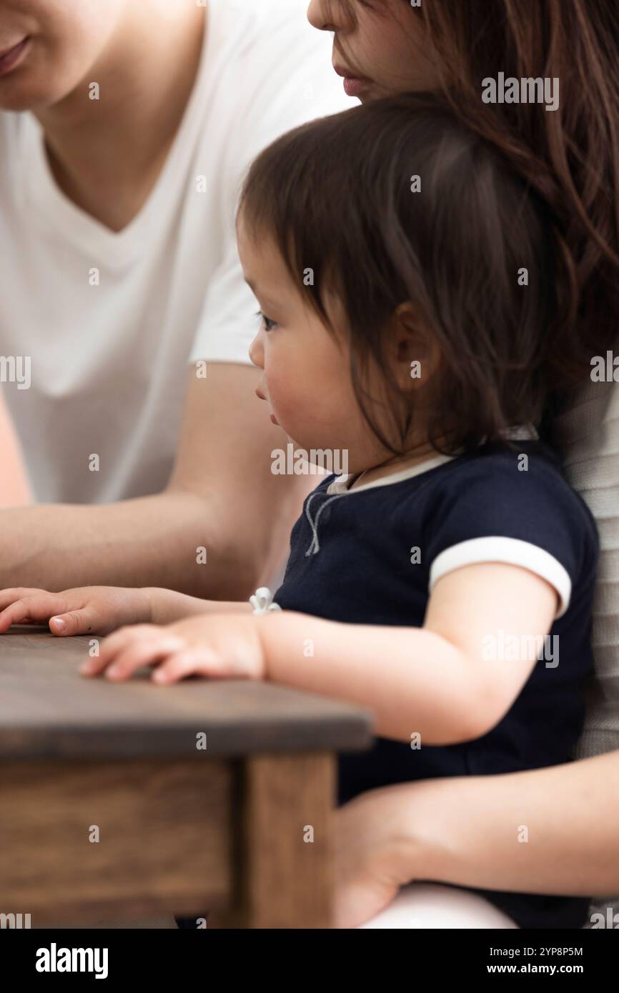 Parents showing tablet to child Stock Photo - Alamy