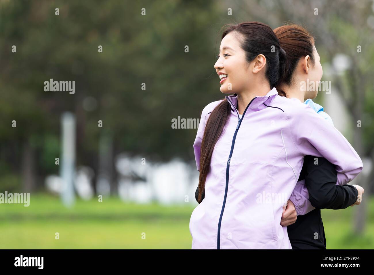 Two women doing back stretches Stock Photo - Alamy