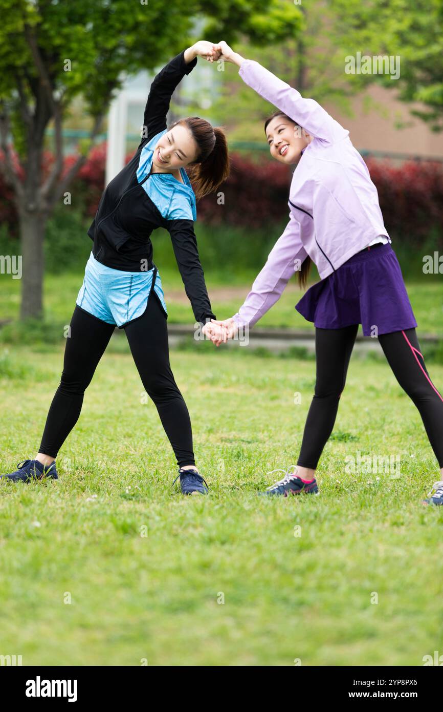 Two women stretching Stock Photo - Alamy