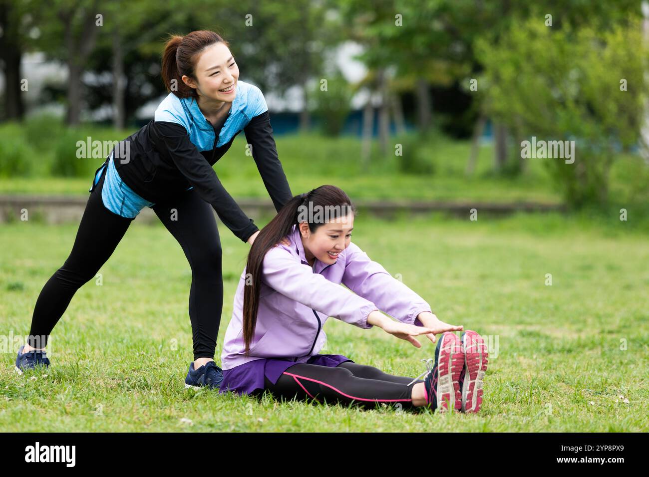 Two women stretching Stock Photo - Alamy