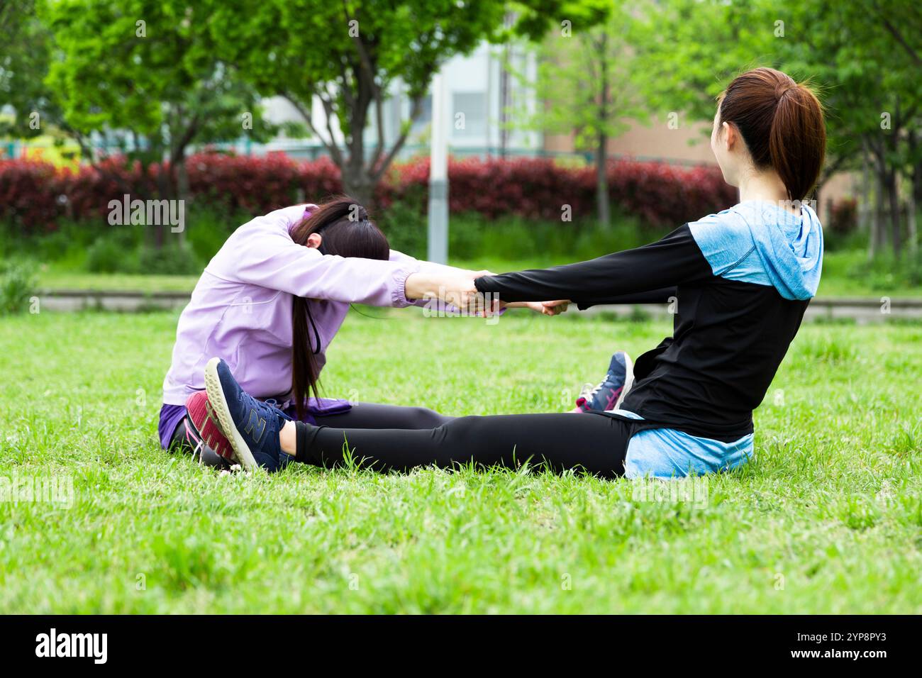 Two women stretching Stock Photo - Alamy