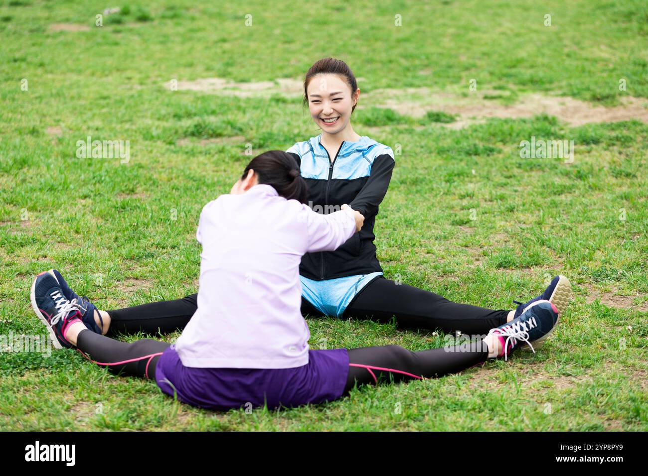 Two women stretching Stock Photo - Alamy