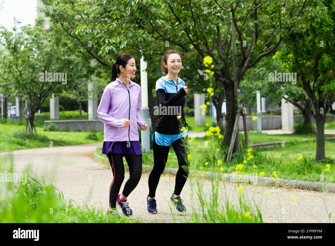 Two women jogging Stock Photo - Alamy