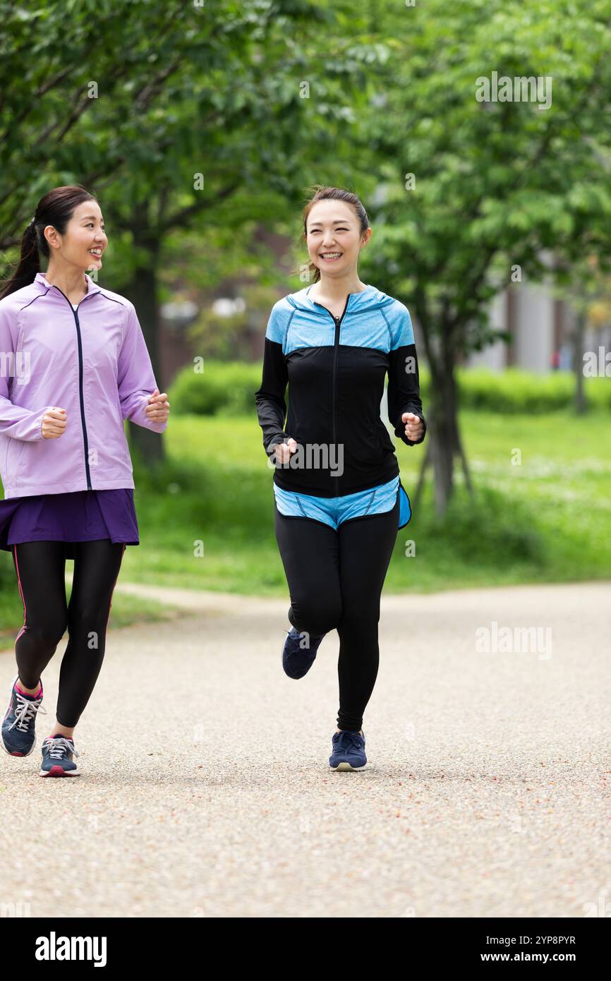 Two women jogging Stock Photo - Alamy