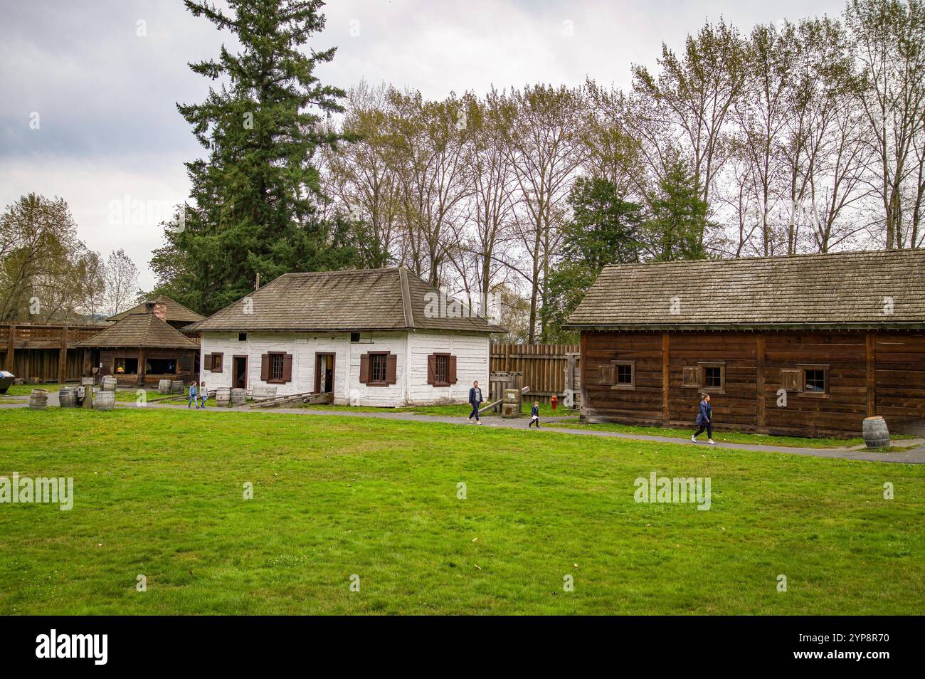 Visitors walk by historic buildings at Fort Langley (1827), a fur ...