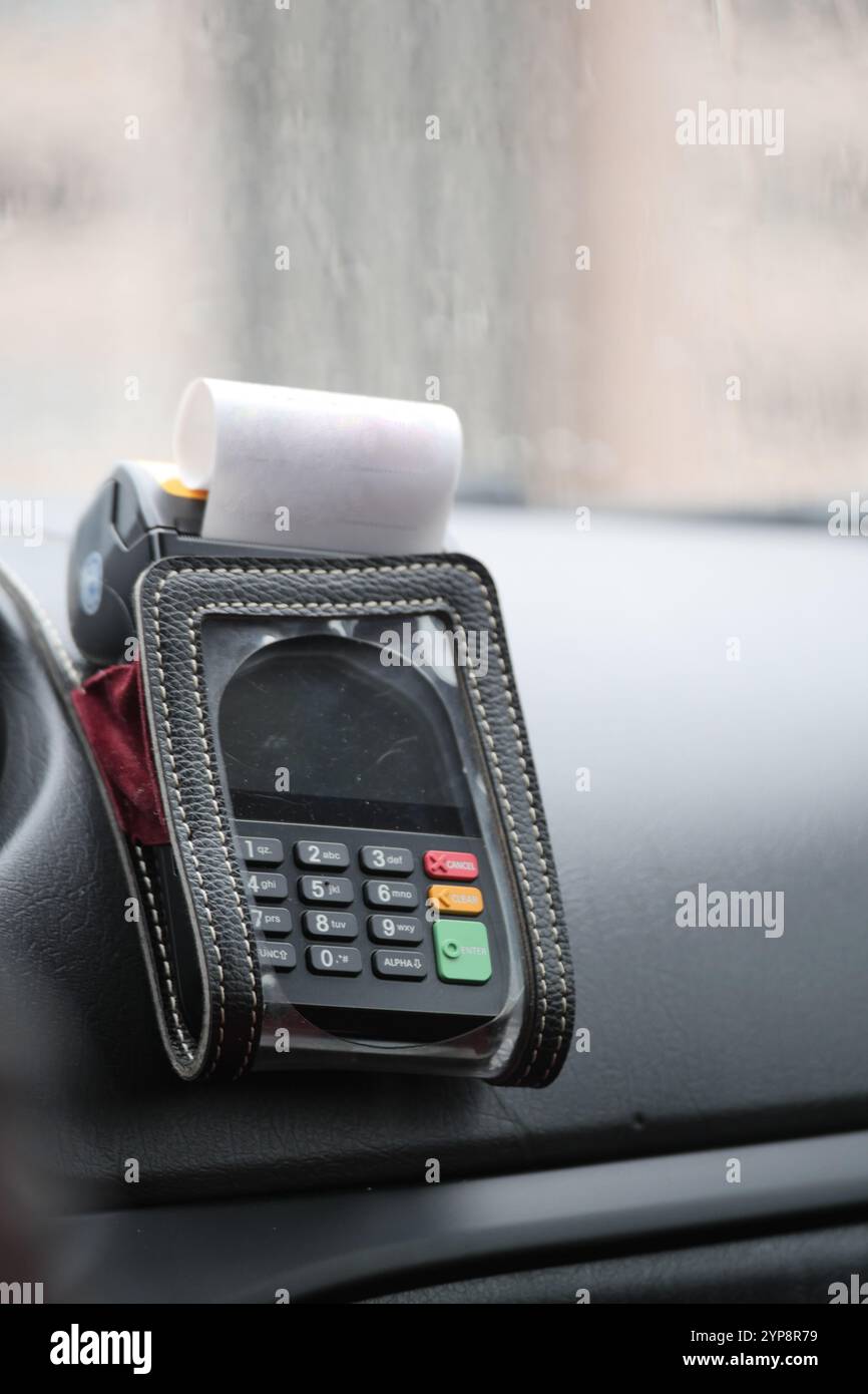 POS machine on yellow taxi Stock Photo - Alamy