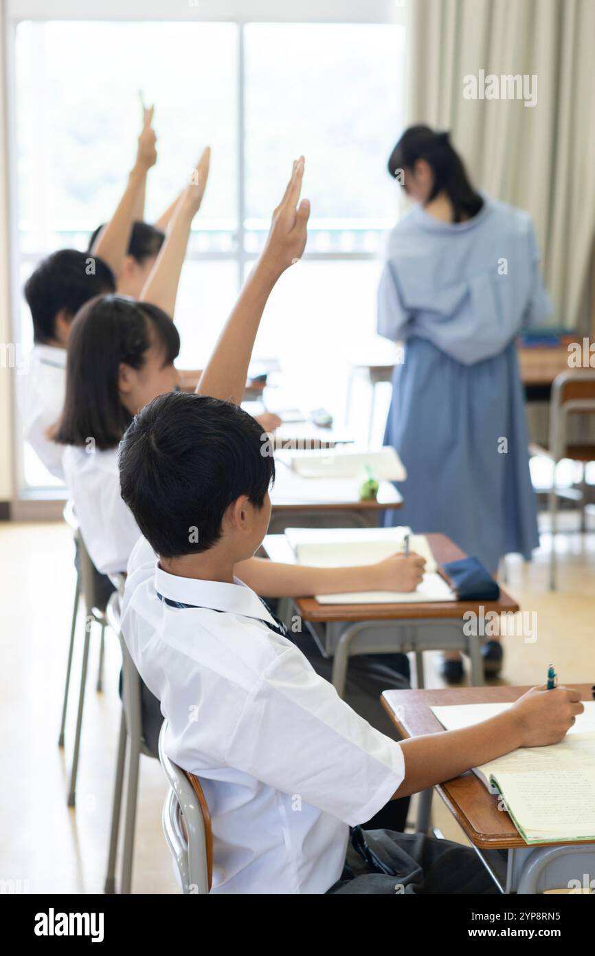 School desk hand raised hi-res stock photography and images - Alamy