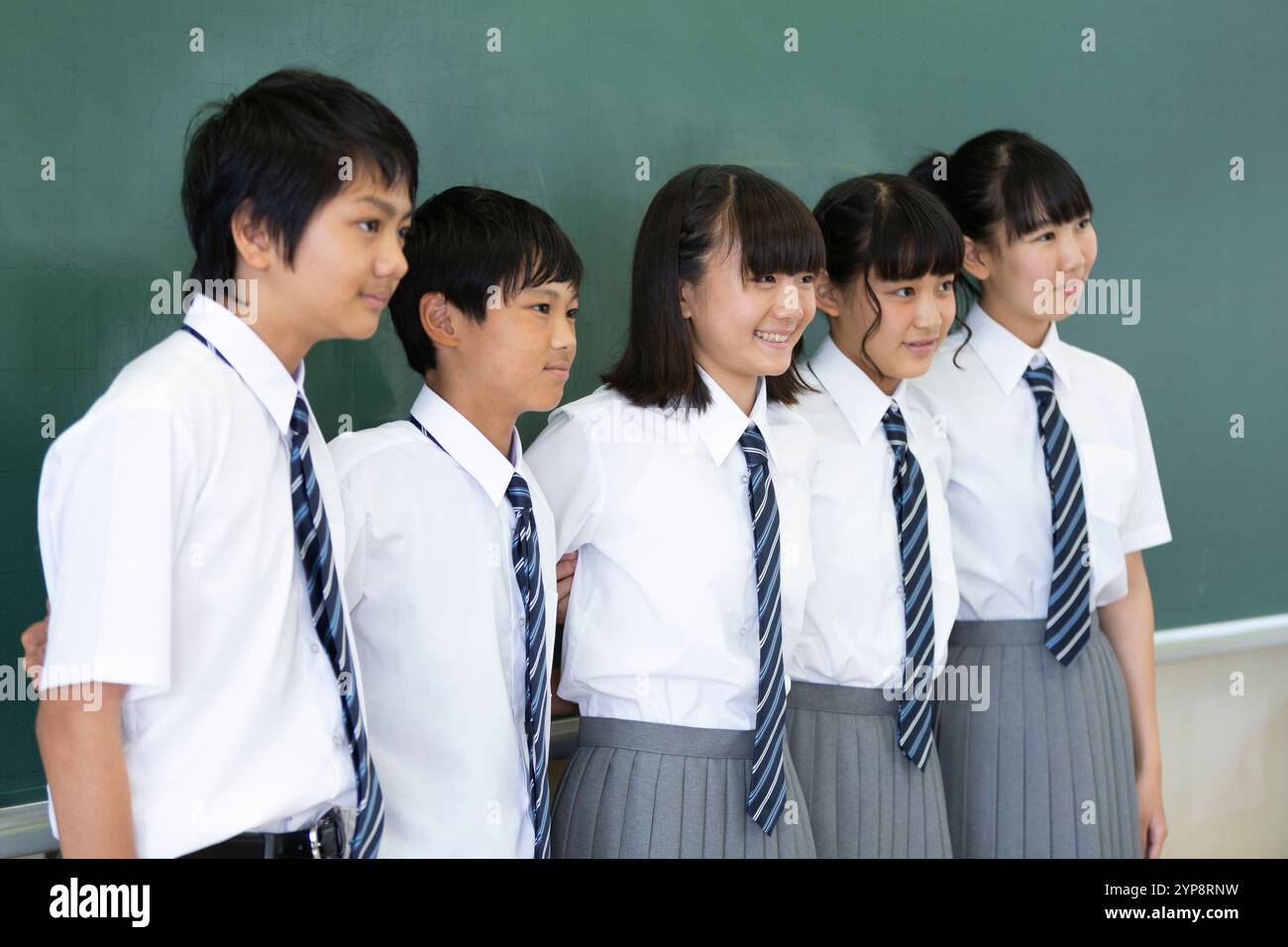 Junior high school students lined up in front of blackboard Stock Photo ...