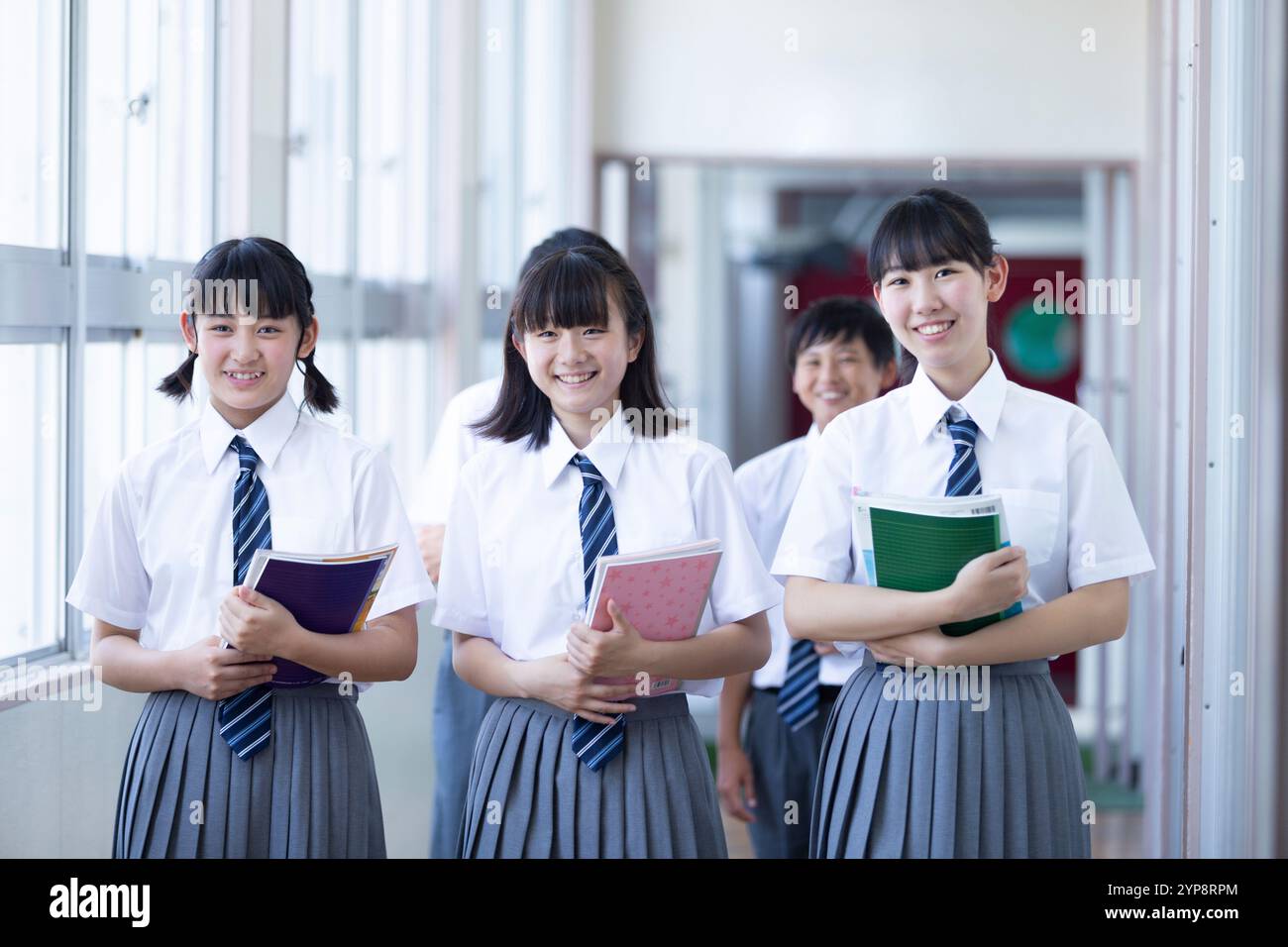 Junior high school students walking in corridor Stock Photo - Alamy